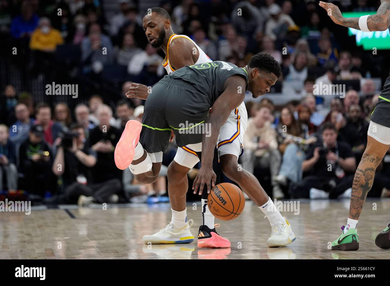 Minnesota Timberwolves guard Anthony Edwards (5), front, loses control ...