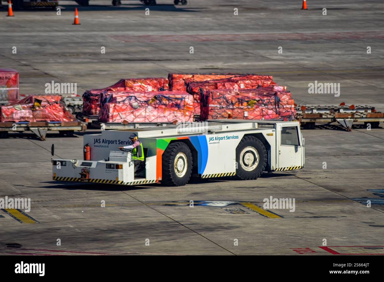 an airport employee driving a push back car on the taxi way at Juanda ...