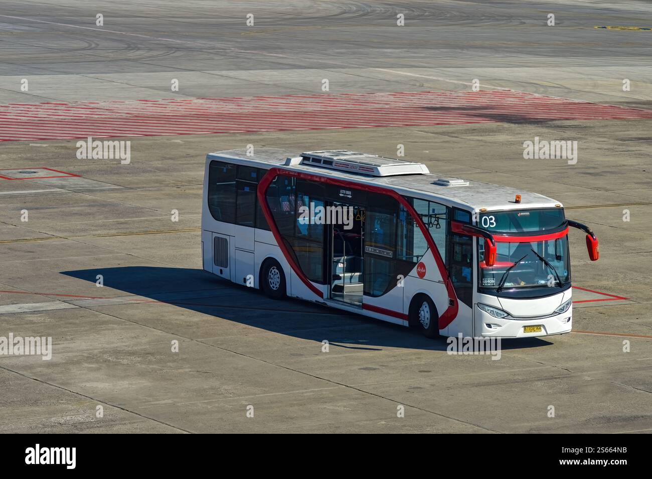 an airport bus belonging to the airline air asia prepares to pick up ...