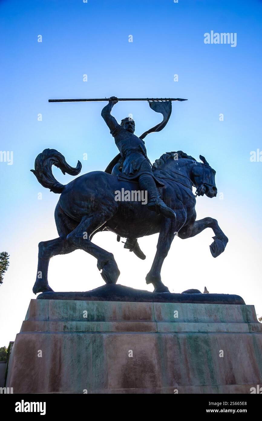 A statue of a man riding a horse with a sword in his hand. The statue ...