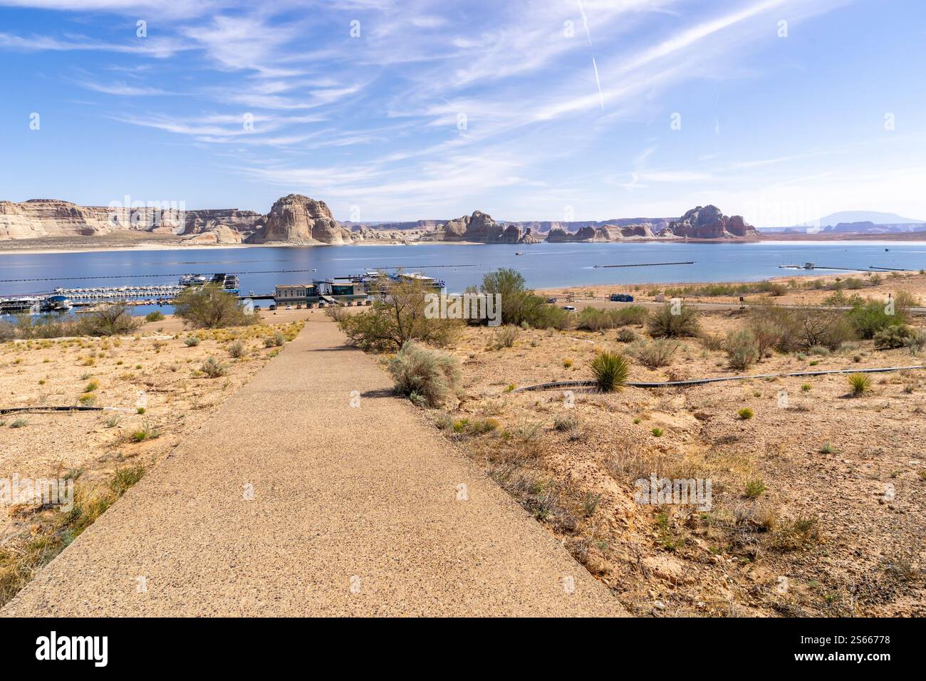 A path to Wahweap Marina at Lake Powell with blue sky and light clouds ...
