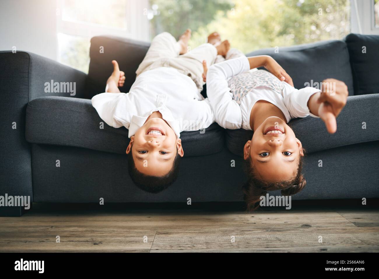 Portrait, upside down or happy kids on sofa with thumbs up, care or ...