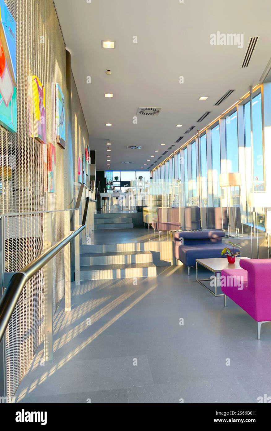 Long foyer with windows of a modern building. Plants and interior ...