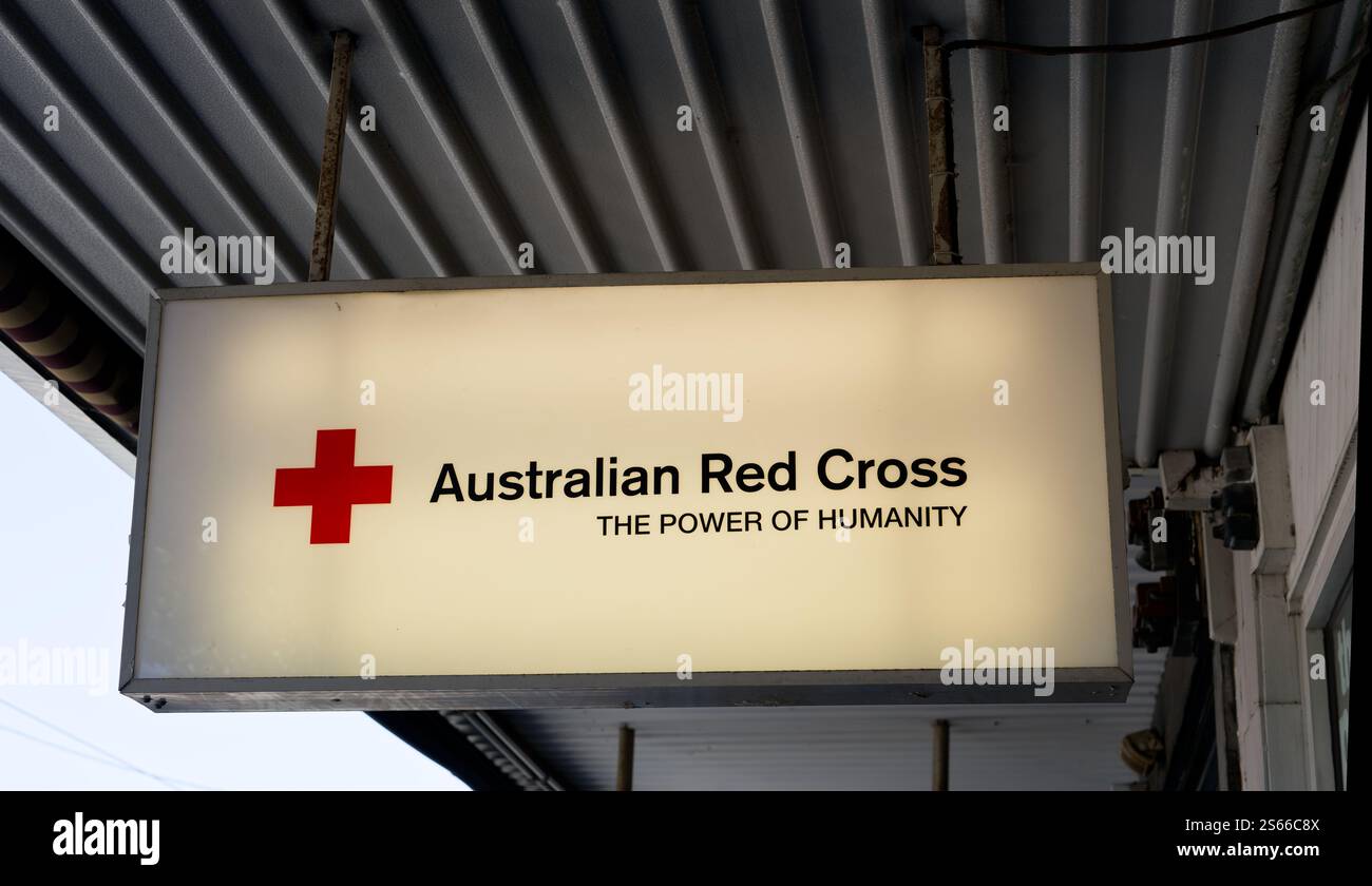 Illuminated Australian Red Cross sign, featuring the charity's logo and ...