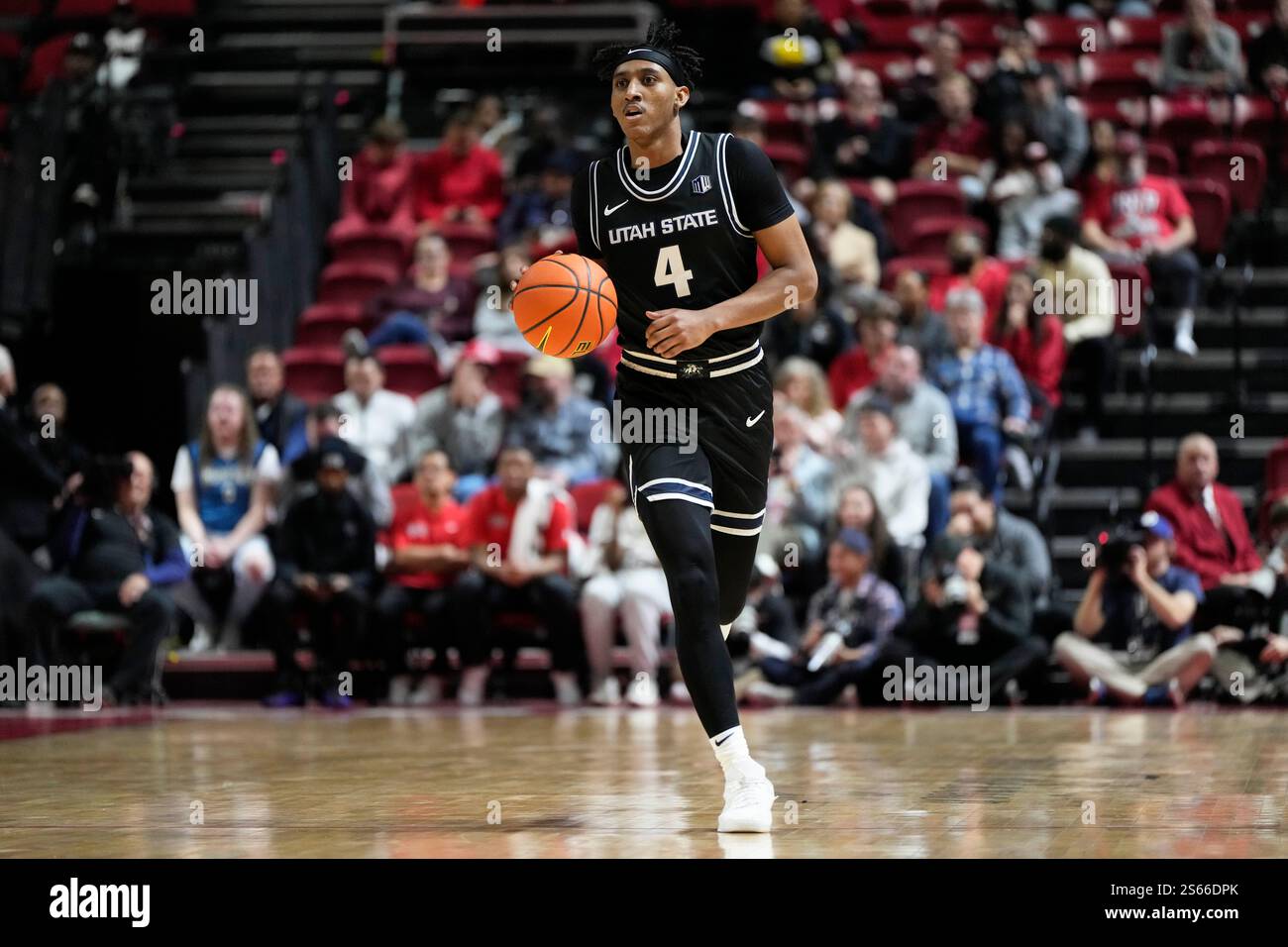 Utah State guard Ian Martinez (4) dribbles the ball against UNLV during ...