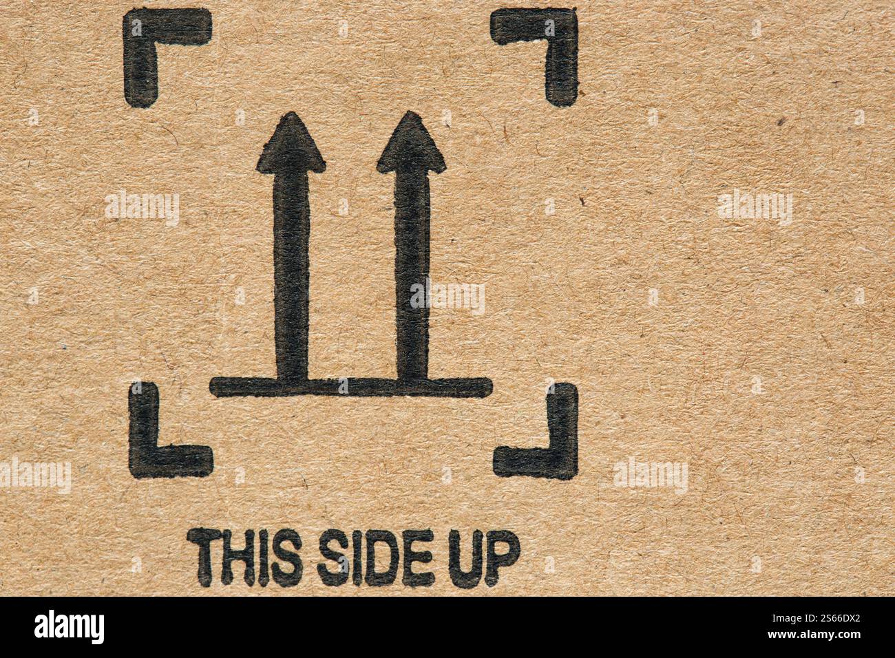 This way up warning printed on a cardboard box background. Cargo freight delivery warning ...