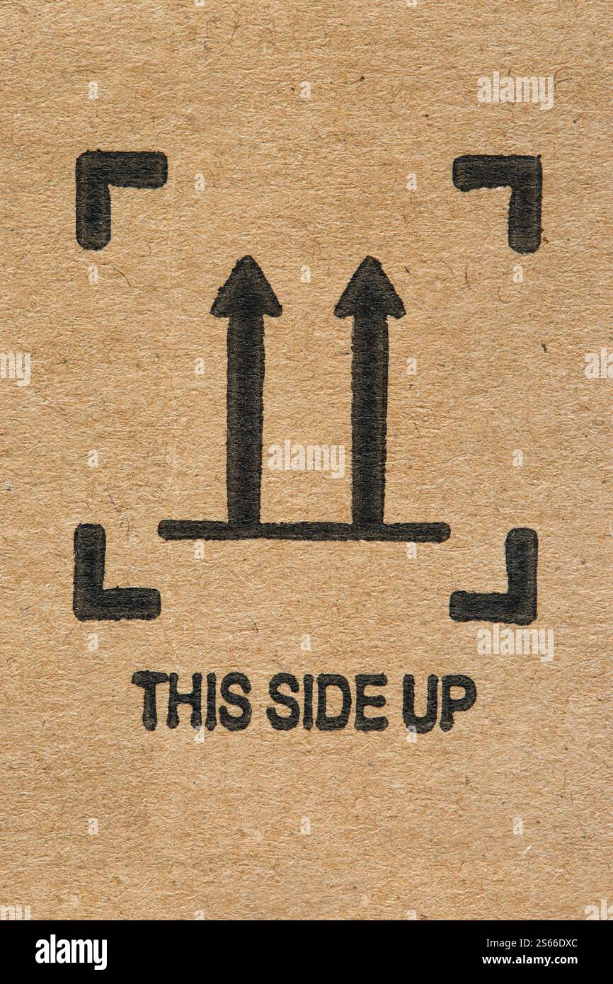 This way up warning printed on a cardboard box background. Cargo freight delivery warning ...