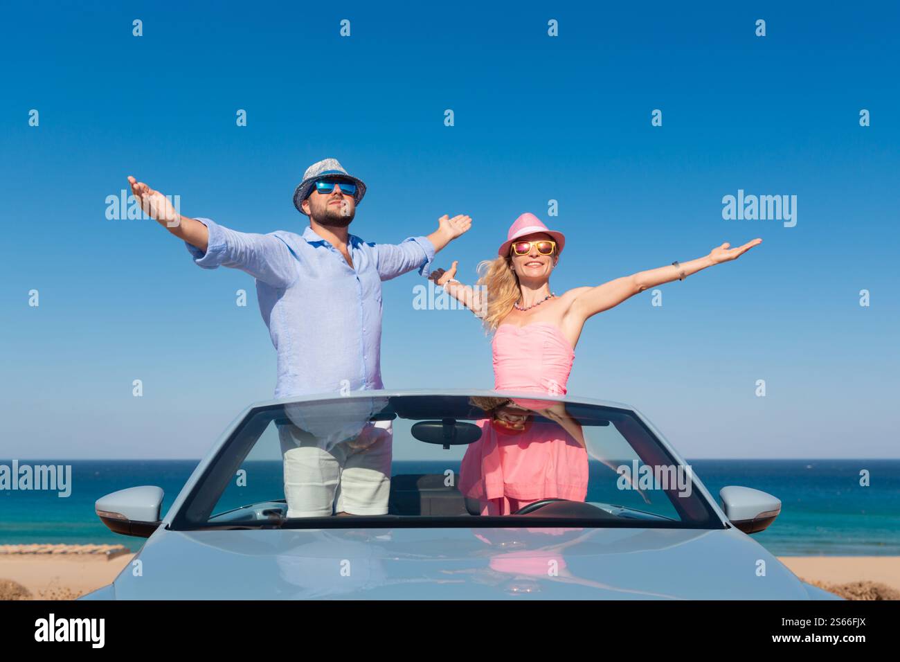 Happy couple in love travel by car by the sea. Young man and woman ...