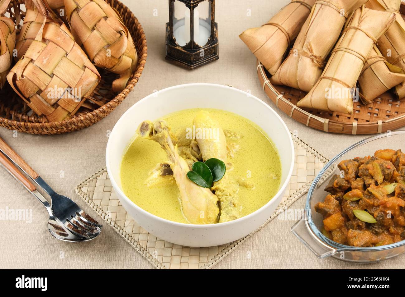 Opor Ayam, served with ketupat, sambal goreng ati, keripik kentang and ...
