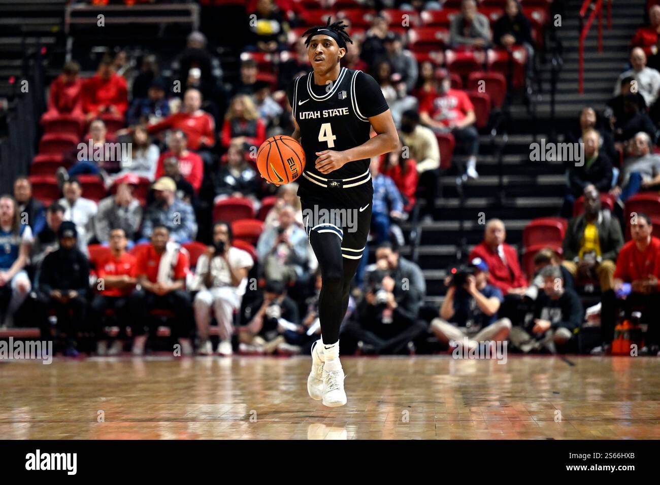 Utah State guard Ian Martinez (4) brings the ball up court during the ...