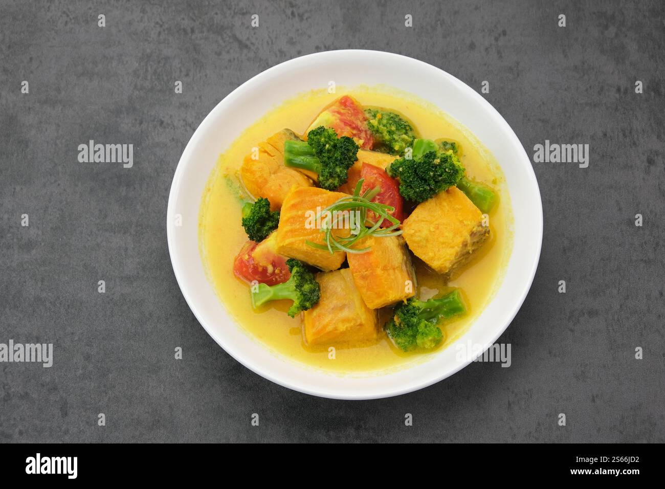 Salmon Kuah Kuning, fish soup with broccoli and tomatoes. Indonesian ...