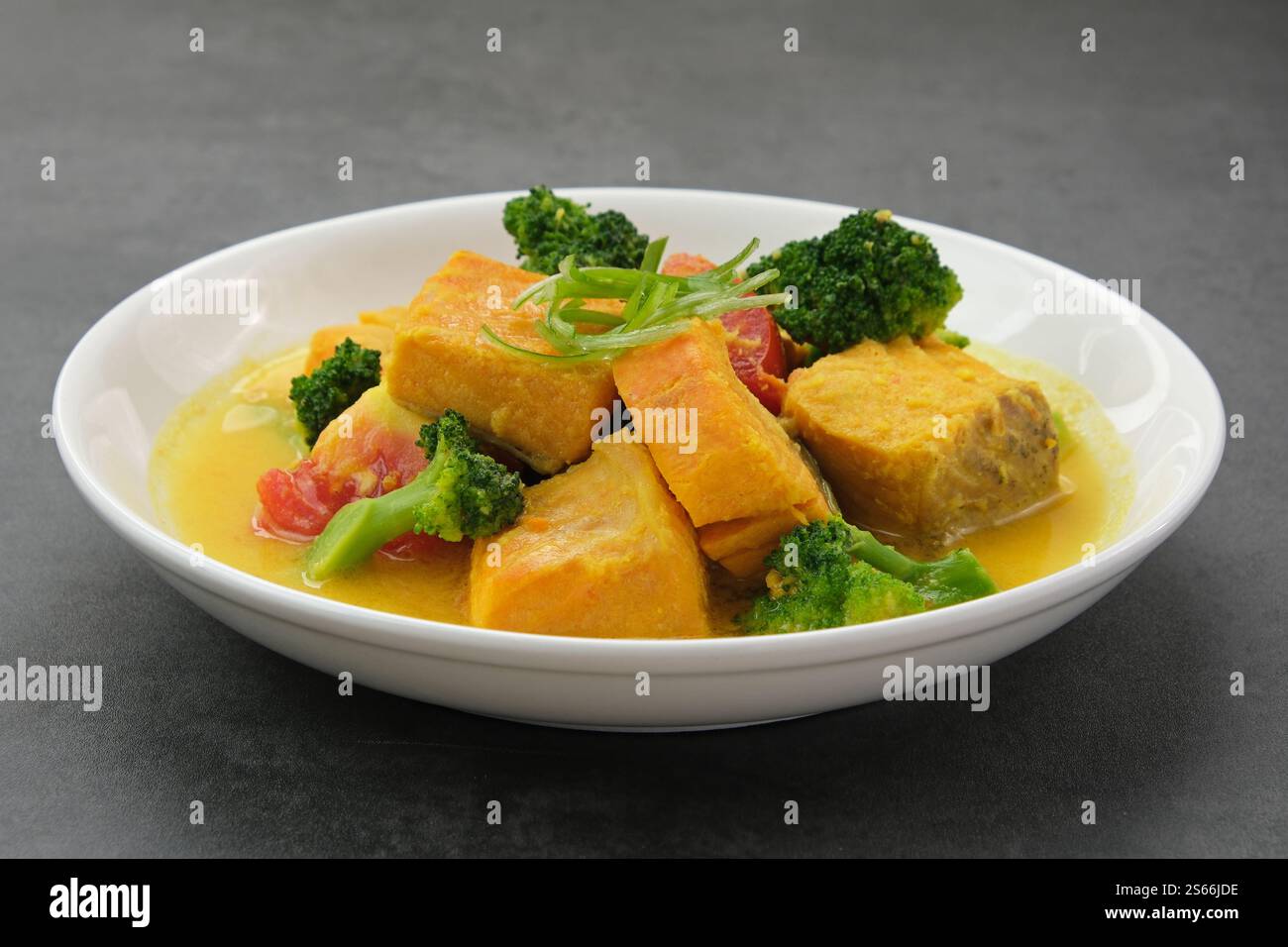 Salmon Kuah Kuning, fish soup with broccoli and tomatoes. Indonesian ...