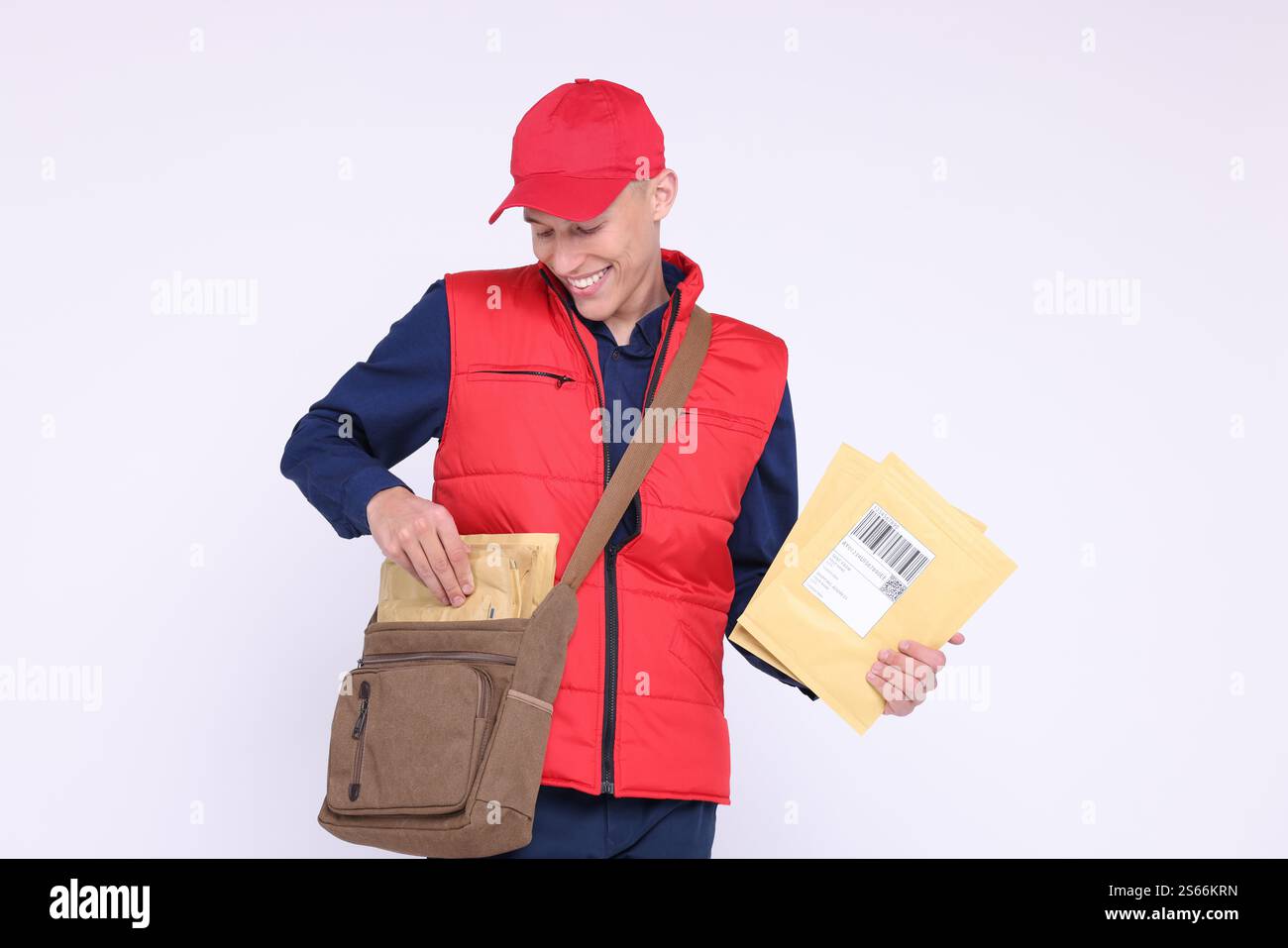 Happy postman with bag and envelopes on white background Stock Photo ...