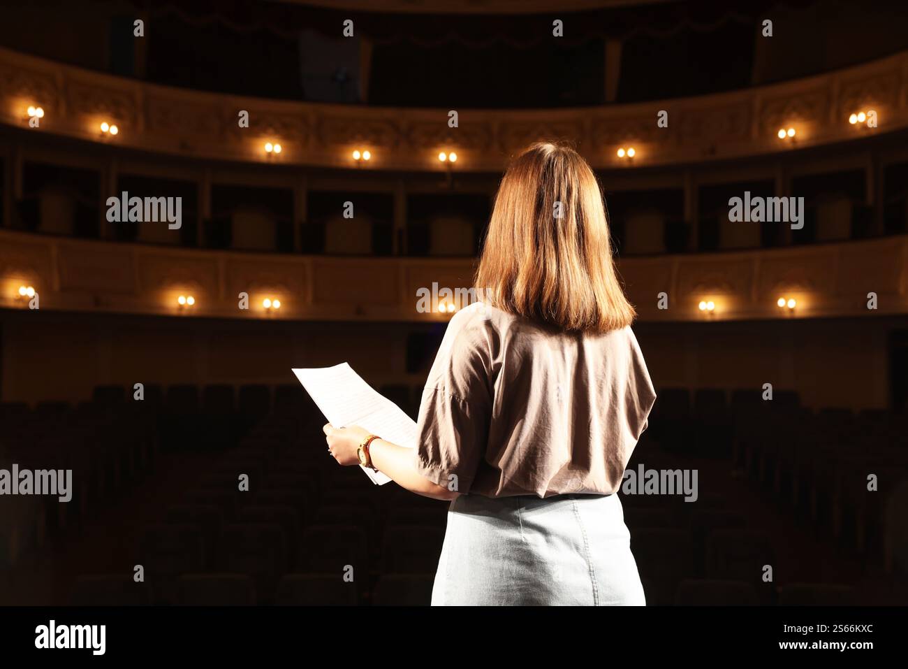 Professional actress rehearsing on stage in theatre, back view Stock ...