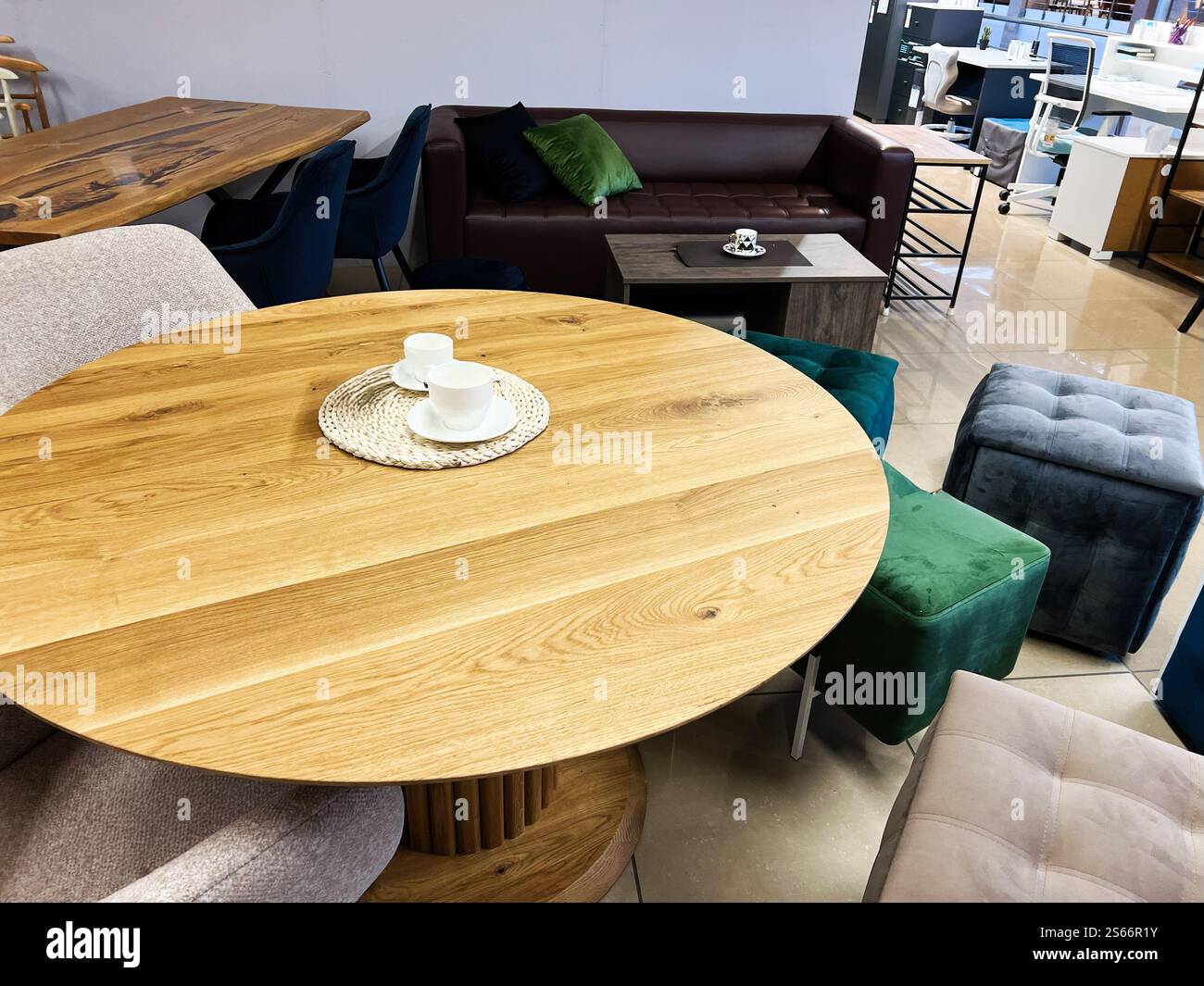 Elegant wooden round table in a contemporary setting with chairs and ...