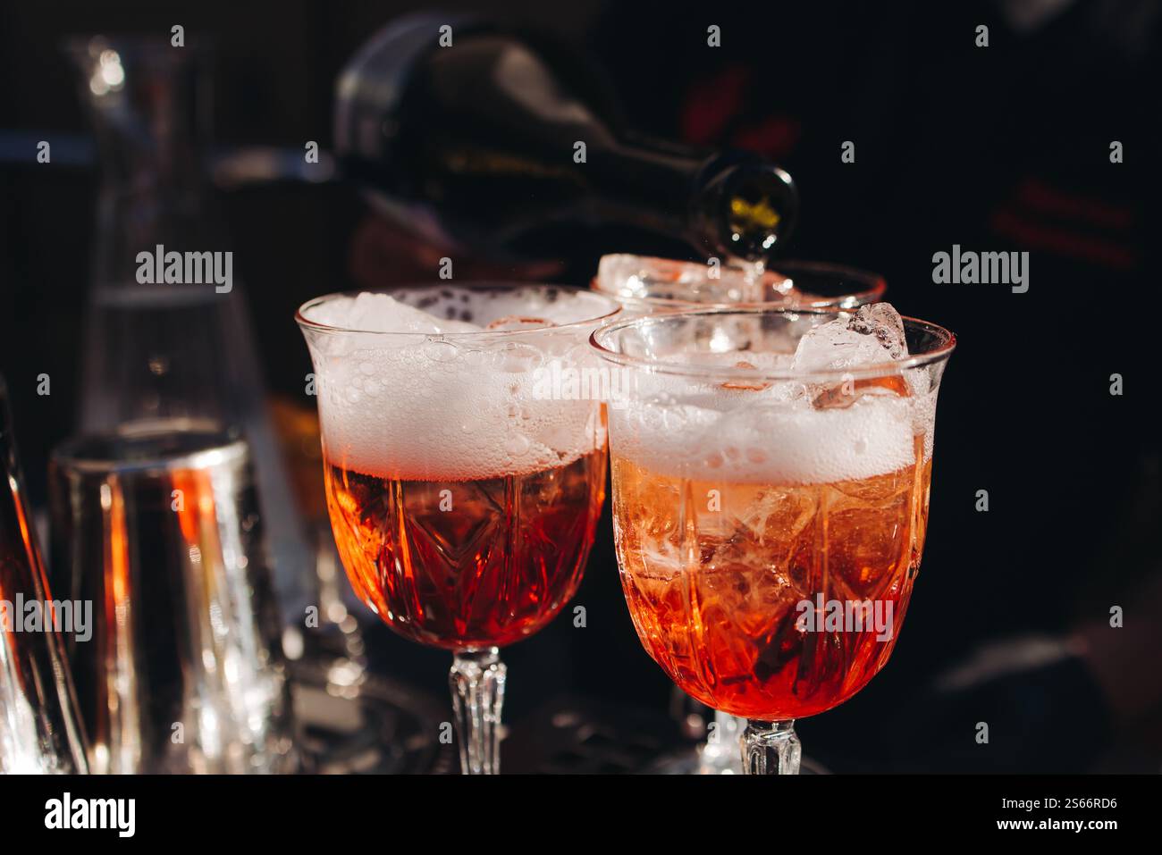 Bartender working, beautiful row line of different coloured liquor ...