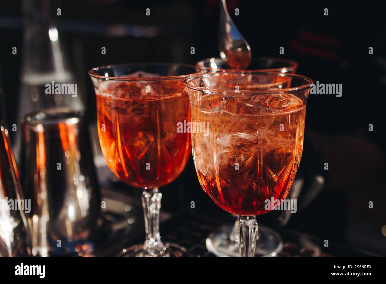 Bartender working, beautiful row line of different coloured liquor ...
