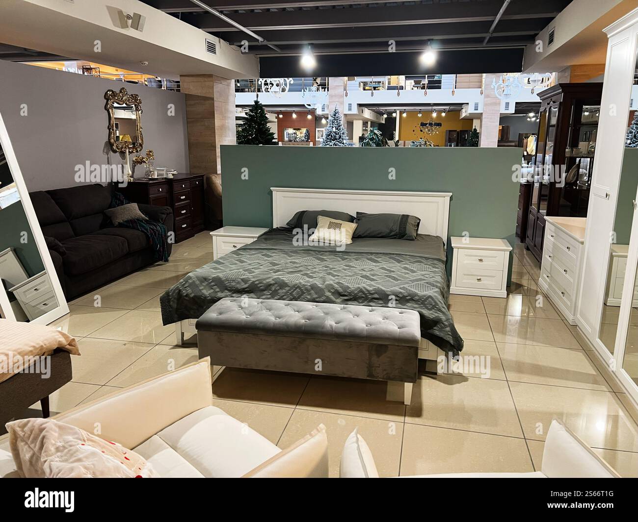 An elegant display of a bedroom set, featuring a white bed frame ...