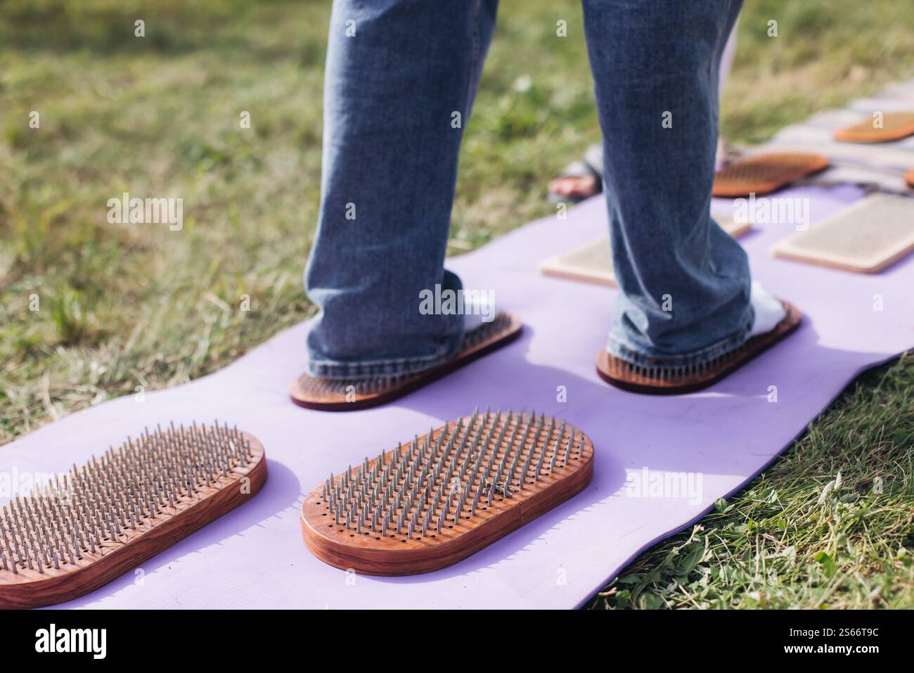 Standing on sadhu board, process of barefoot standing on nails therapy ...