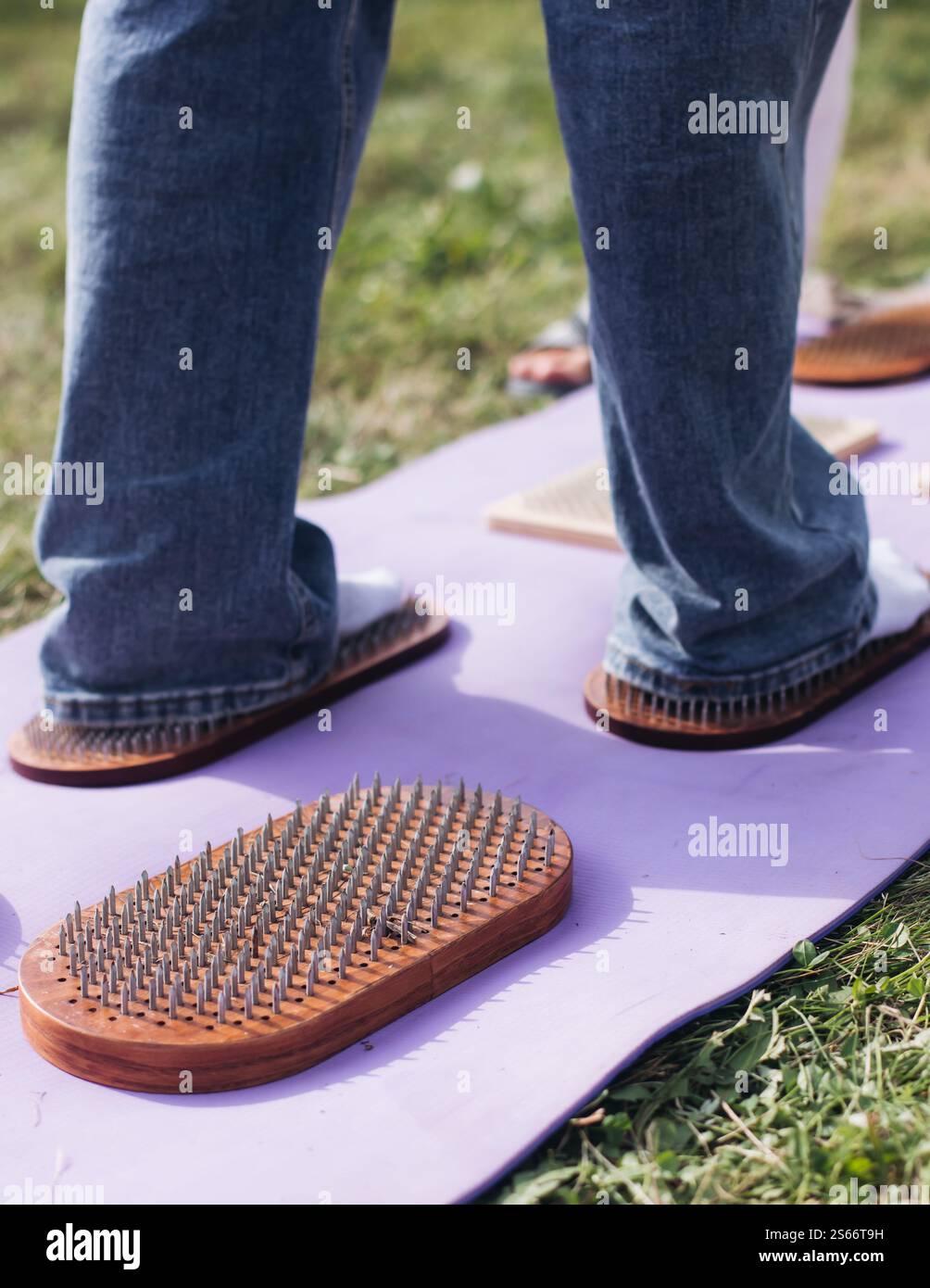 Standing on sadhu board, process of barefoot standing on nails therapy ...