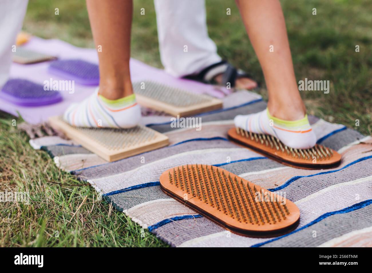 Standing on sadhu board, process of barefoot standing on nails therapy ...