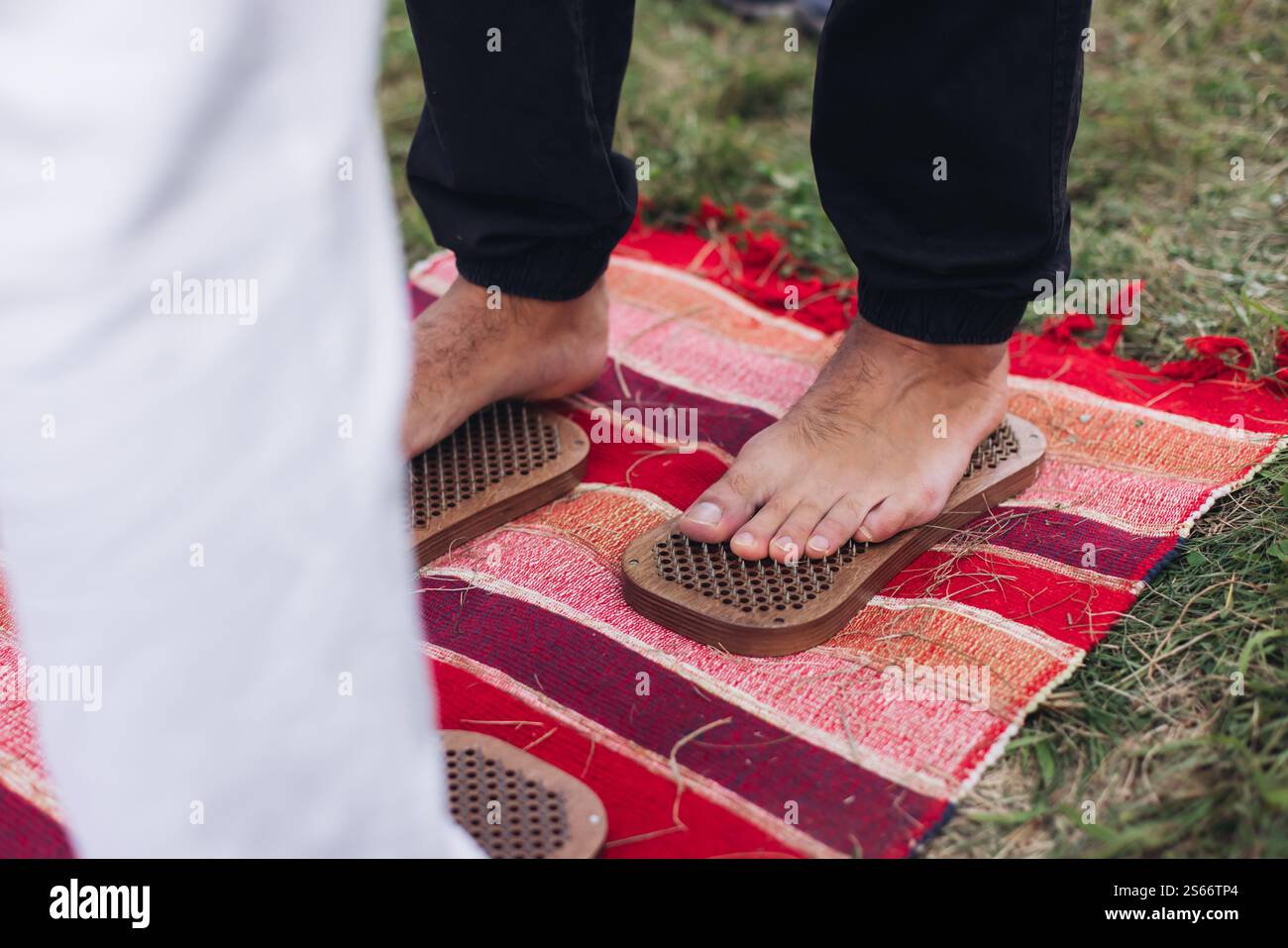 Standing on sadhu board, process of barefoot standing on nails therapy ...