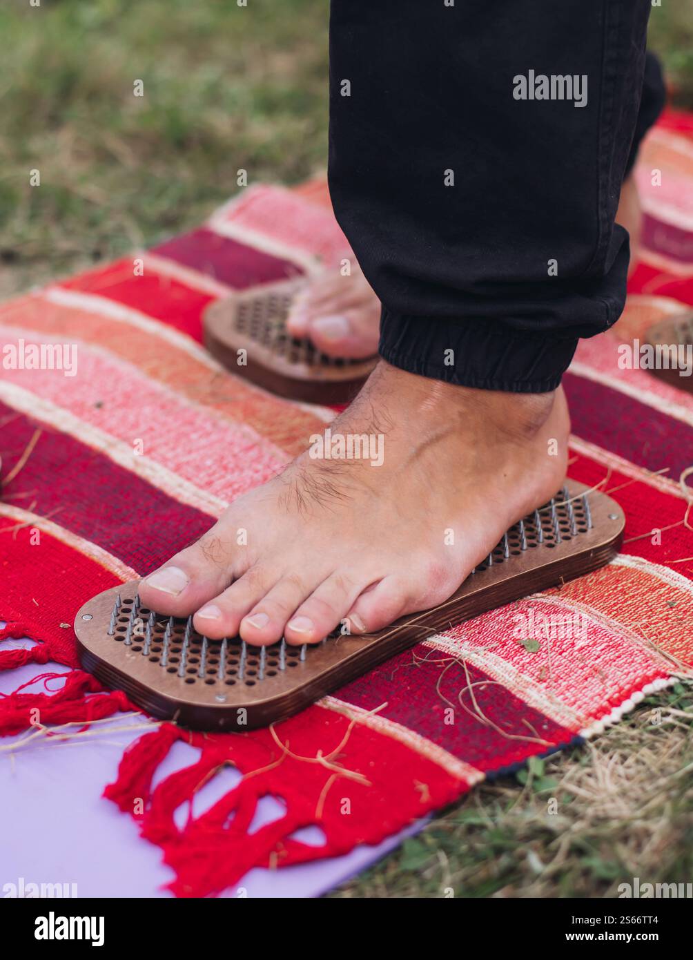 Standing on sadhu board, process of barefoot standing on nails therapy ...