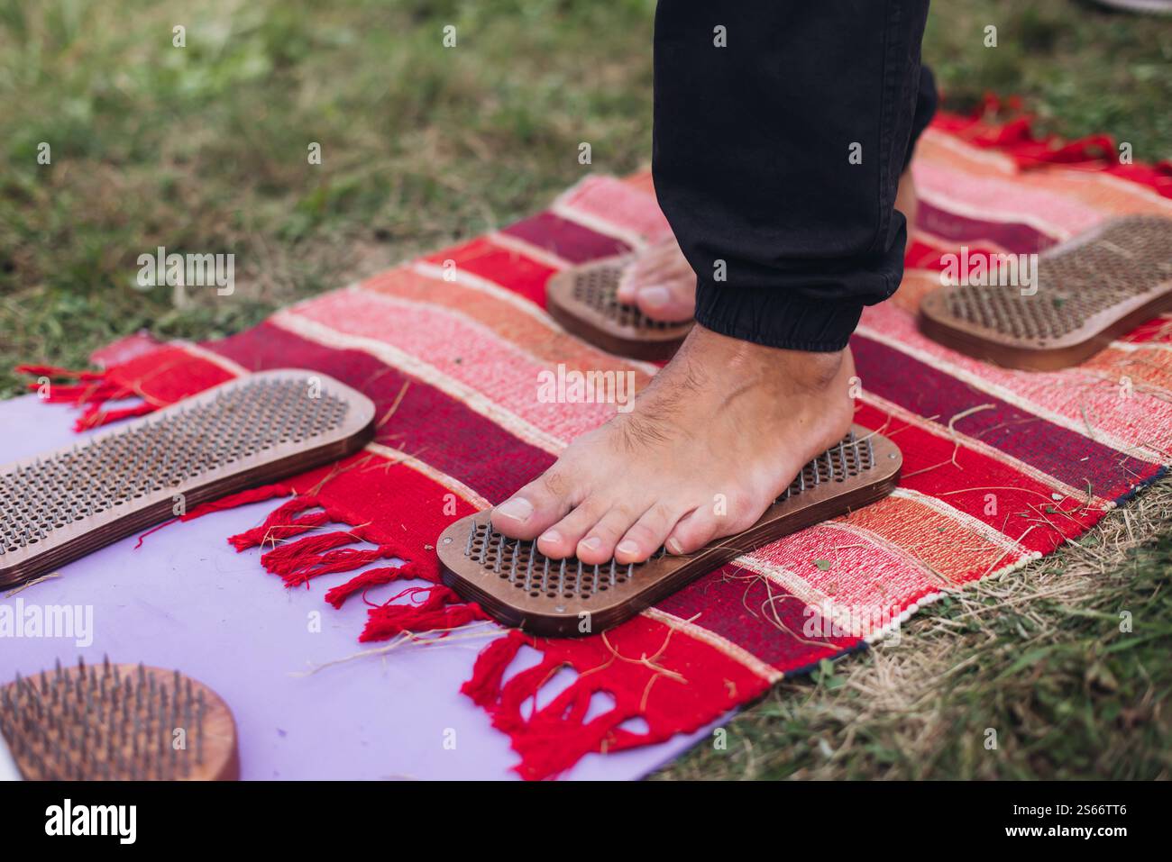 Standing on sadhu board, process of barefoot standing on nails therapy ...