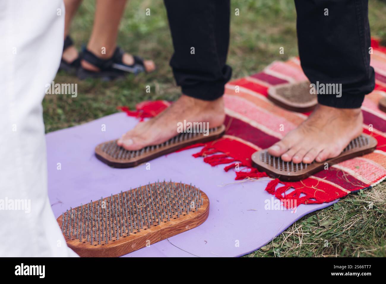 Standing on sadhu board, process of barefoot standing on nails therapy ...