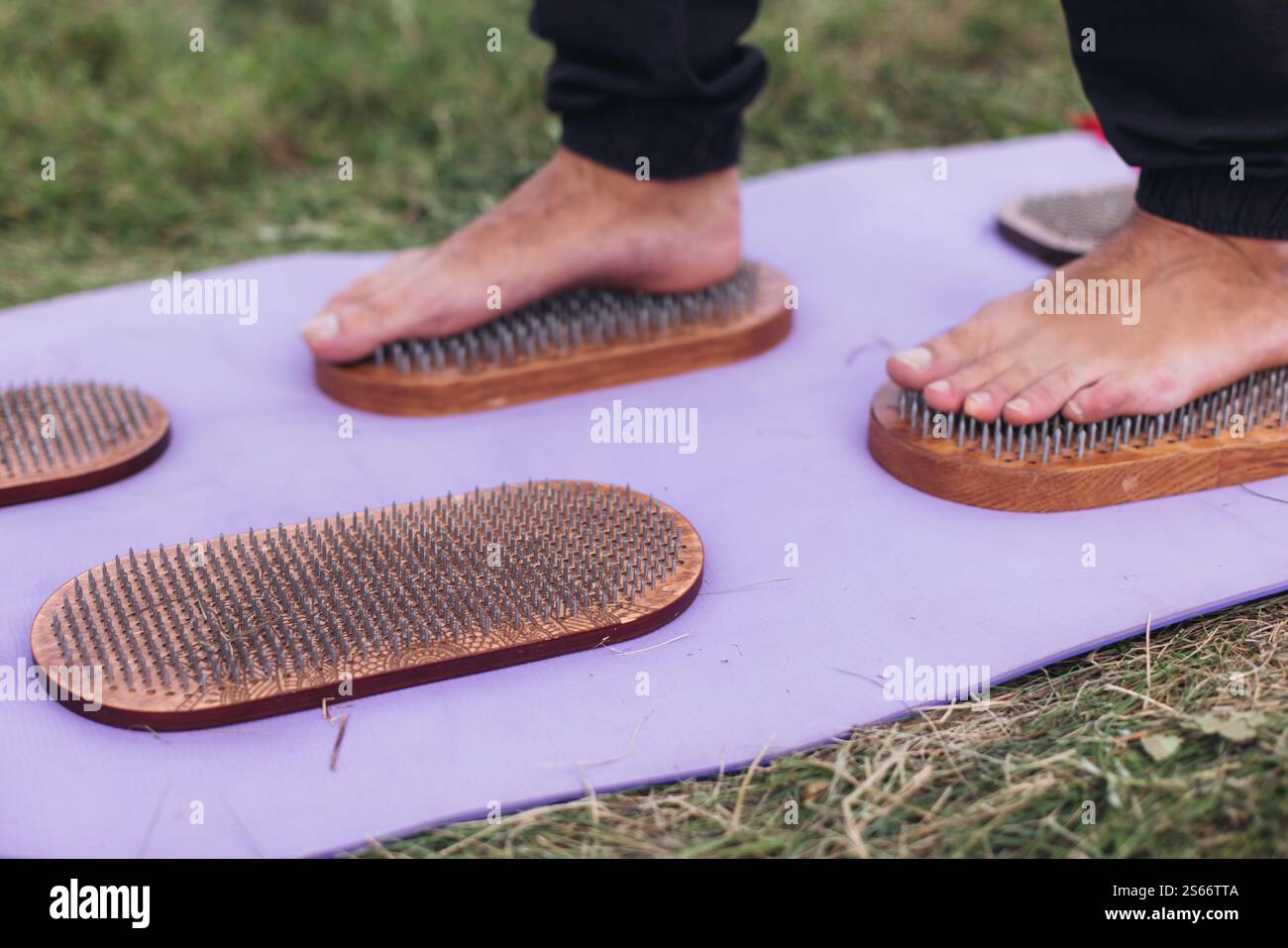 Standing on sadhu board, process of barefoot standing on nails therapy ...
