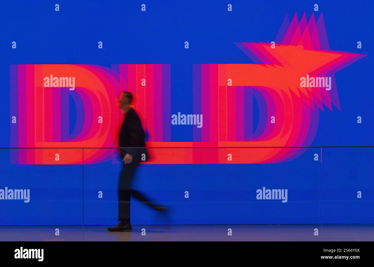 Munich, Germany. 16th Jan, 2025. A visitor to the "Digital Life Design" (DLD) conference walks ...