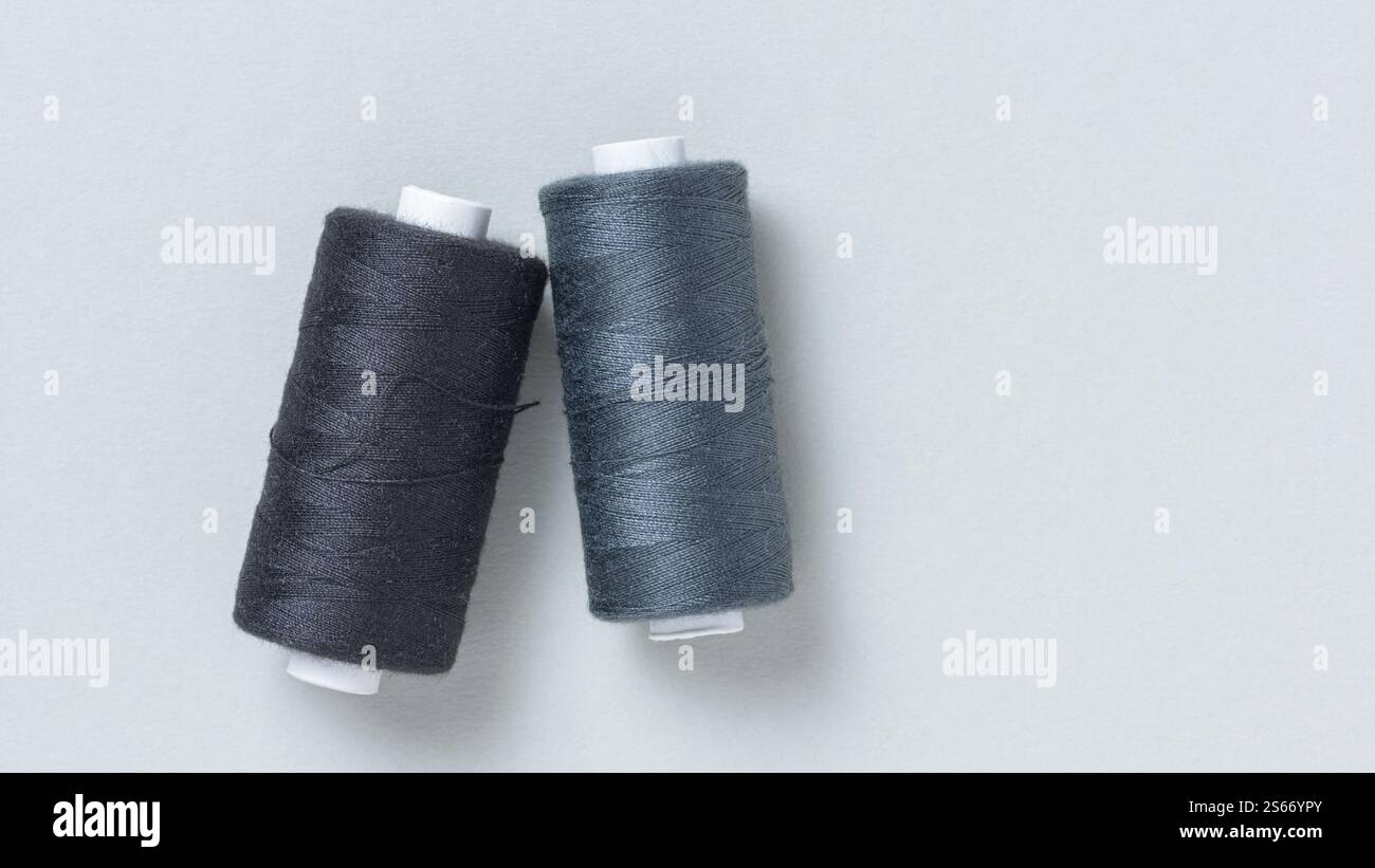 Black grey gray thread spools background with copy space for text close ...