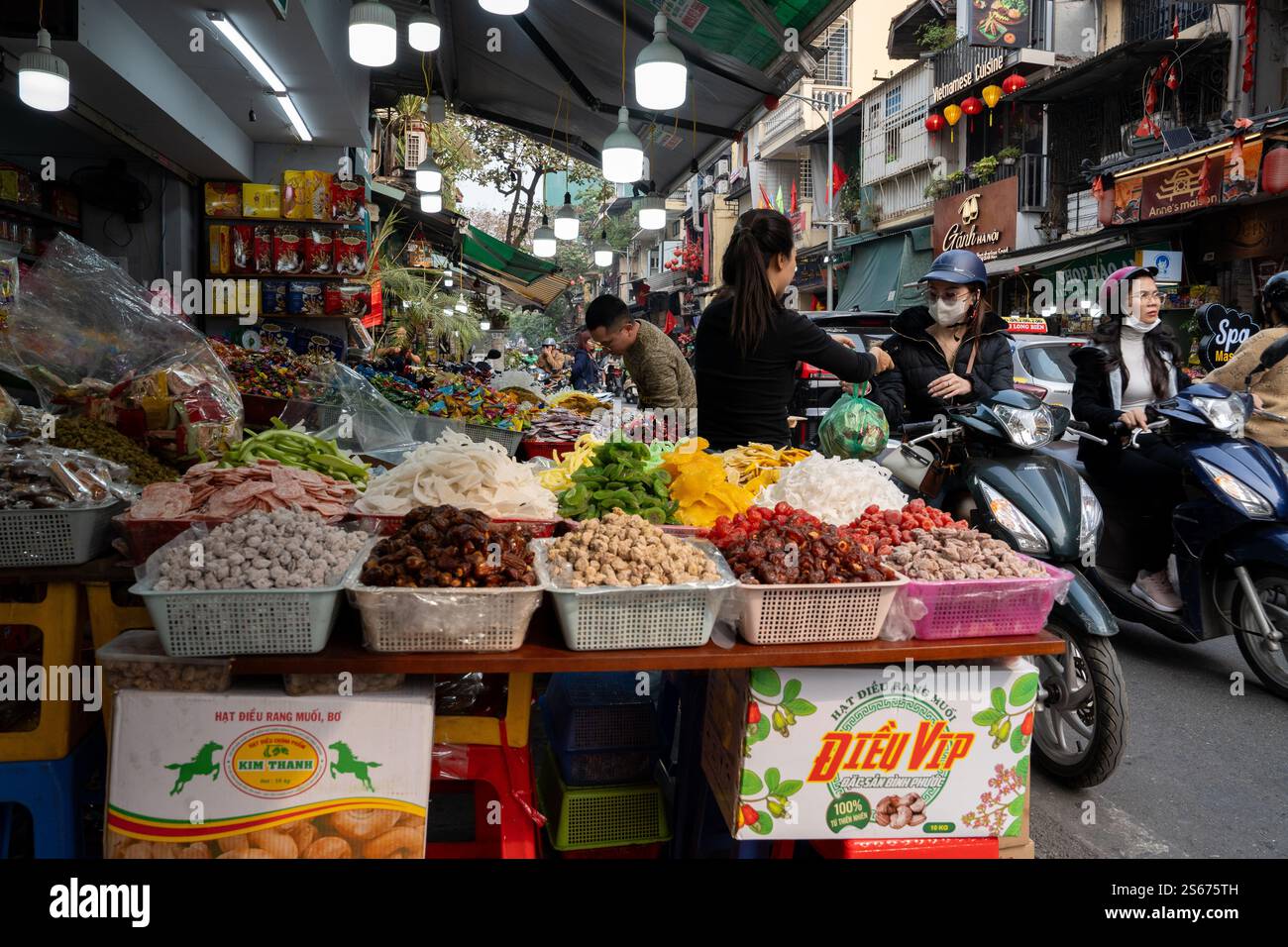 A Vietnamese woman working as a saleswoman together with a customer on ...
