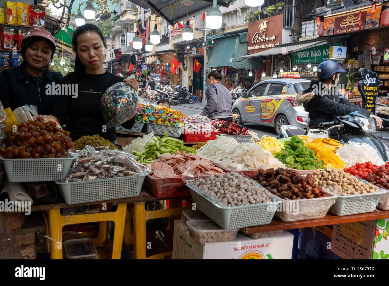 A Vietnamese woman working as a saleswoman together with a customer on ...