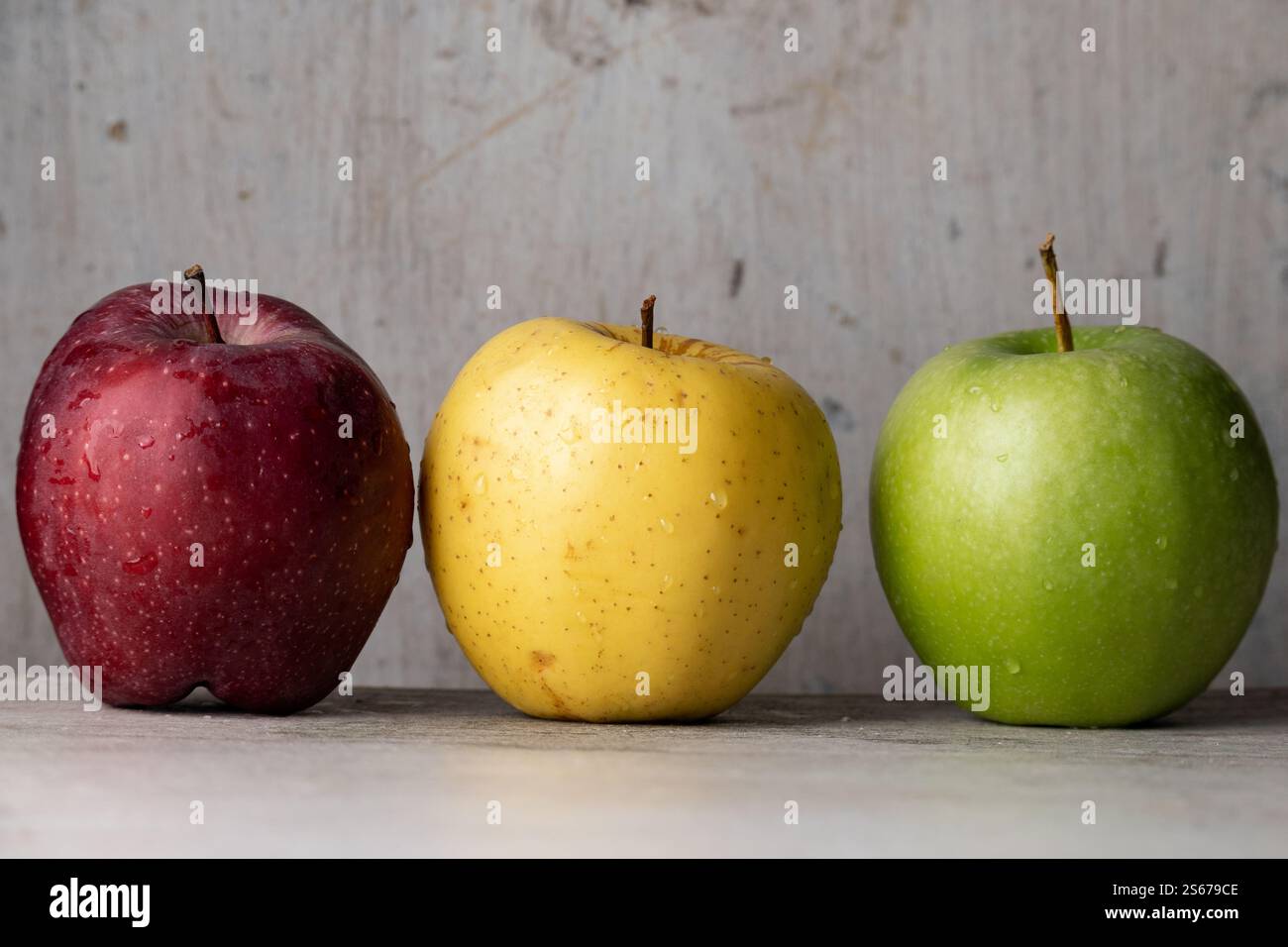 Three apples of different varieties and colors: red, yellow, green Stock Photo - Alamy