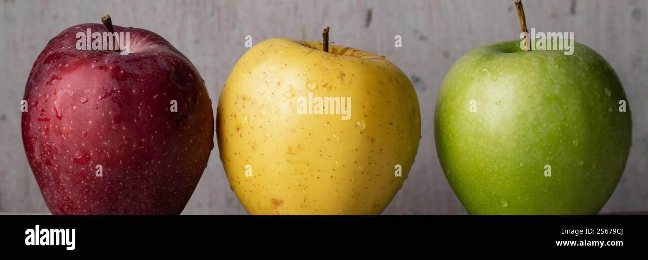 Three apples of different varieties and colors: red, yellow, green Stock Photo - Alamy