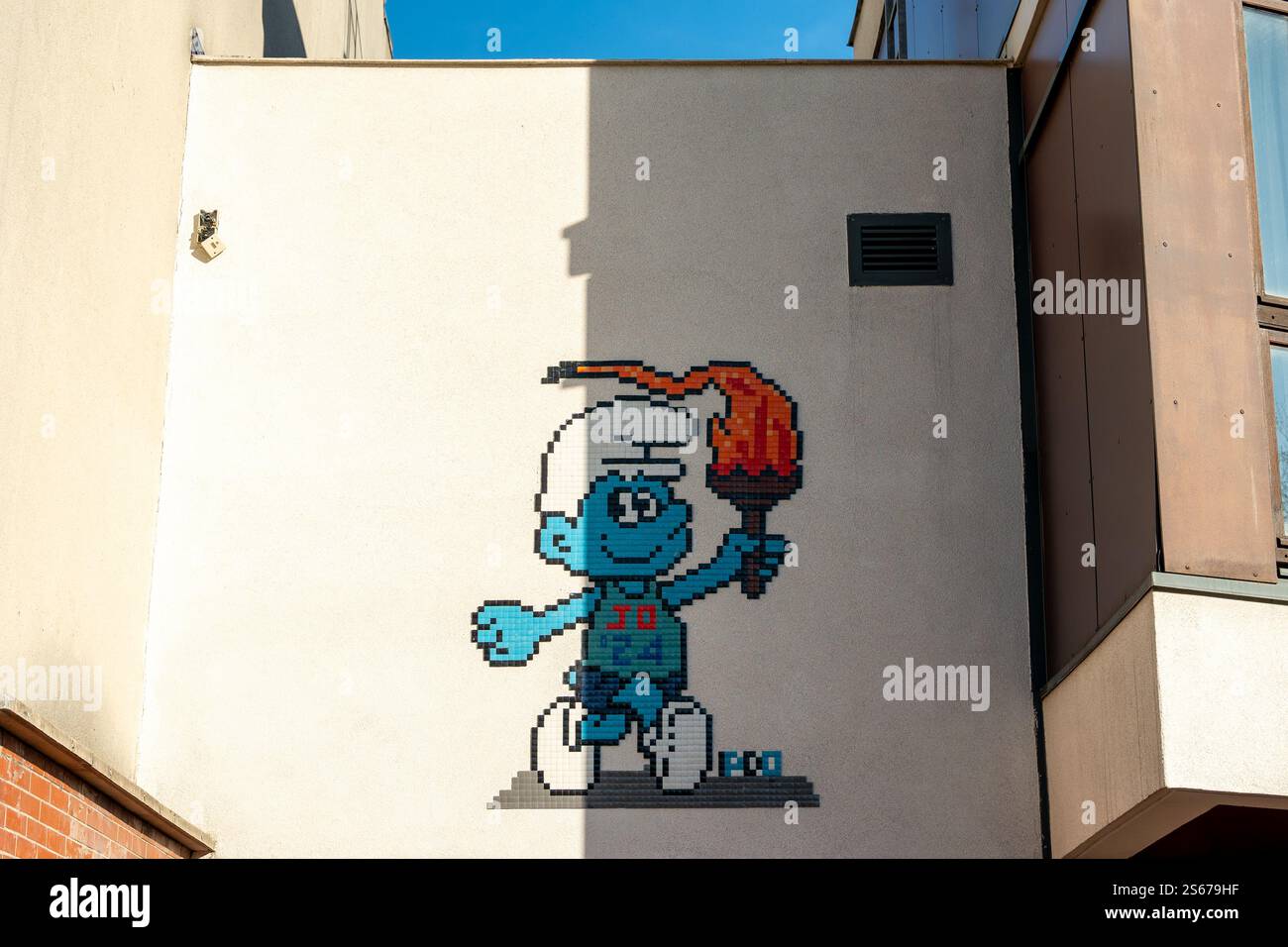 Colorful street art depicting a Smurf holding a torch on a building ...