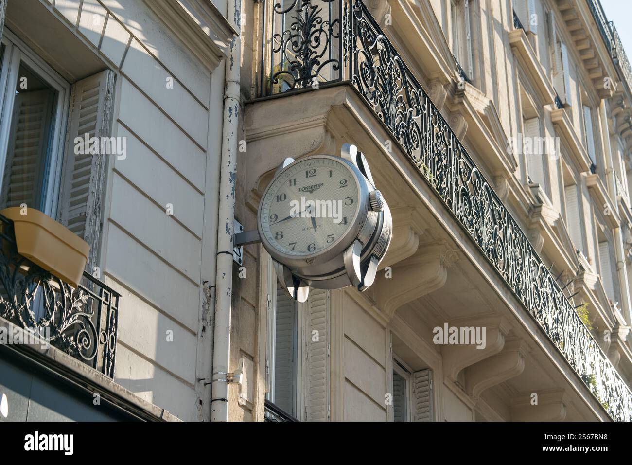 Unique oversized clock on a building in a bustling urban setting in ...