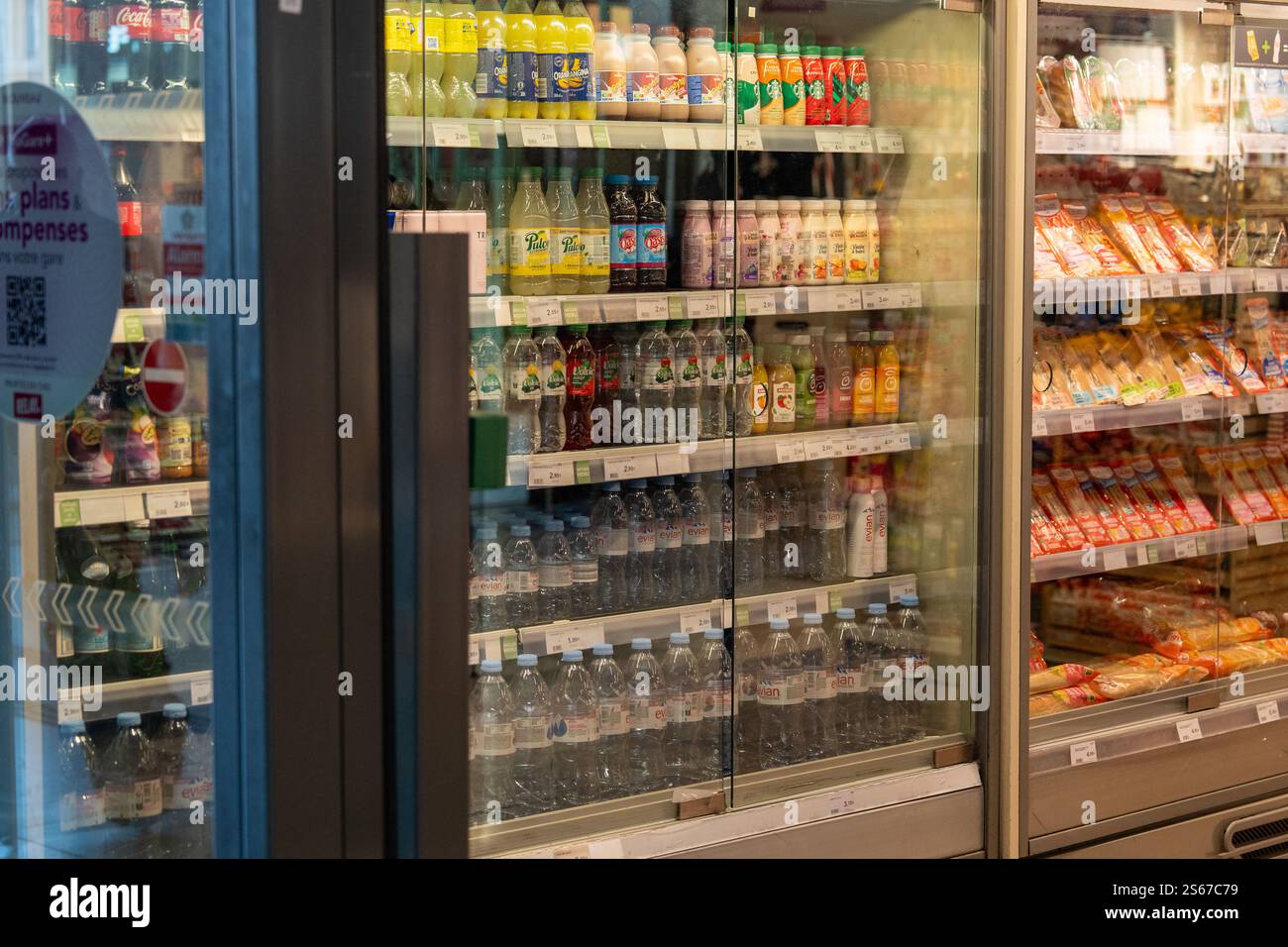 Display of assorted beverages and snacks in a convenience store cooler ...