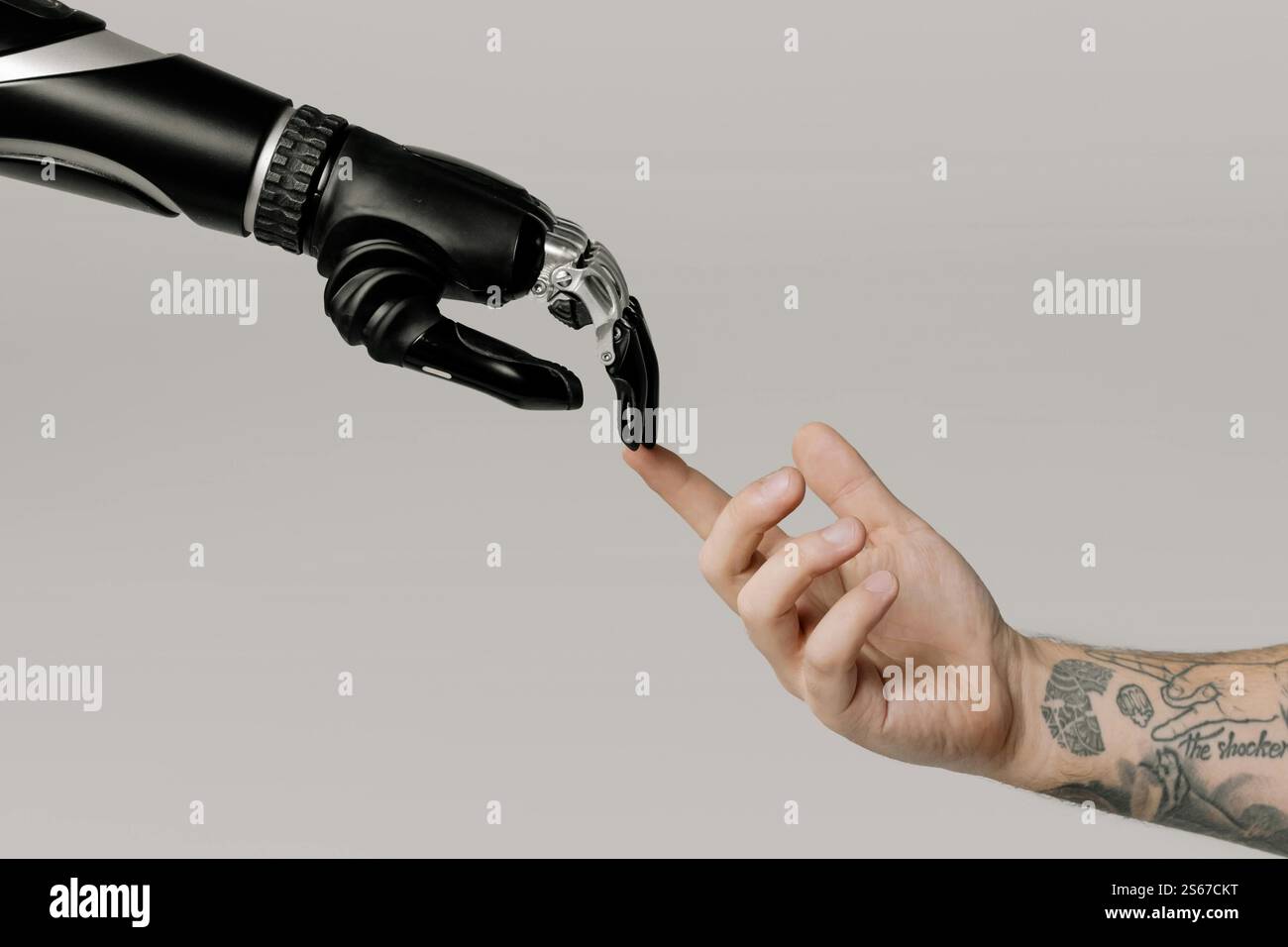 man and bionic arm a robot hand touching a mans hand Stock Photo - Alamy