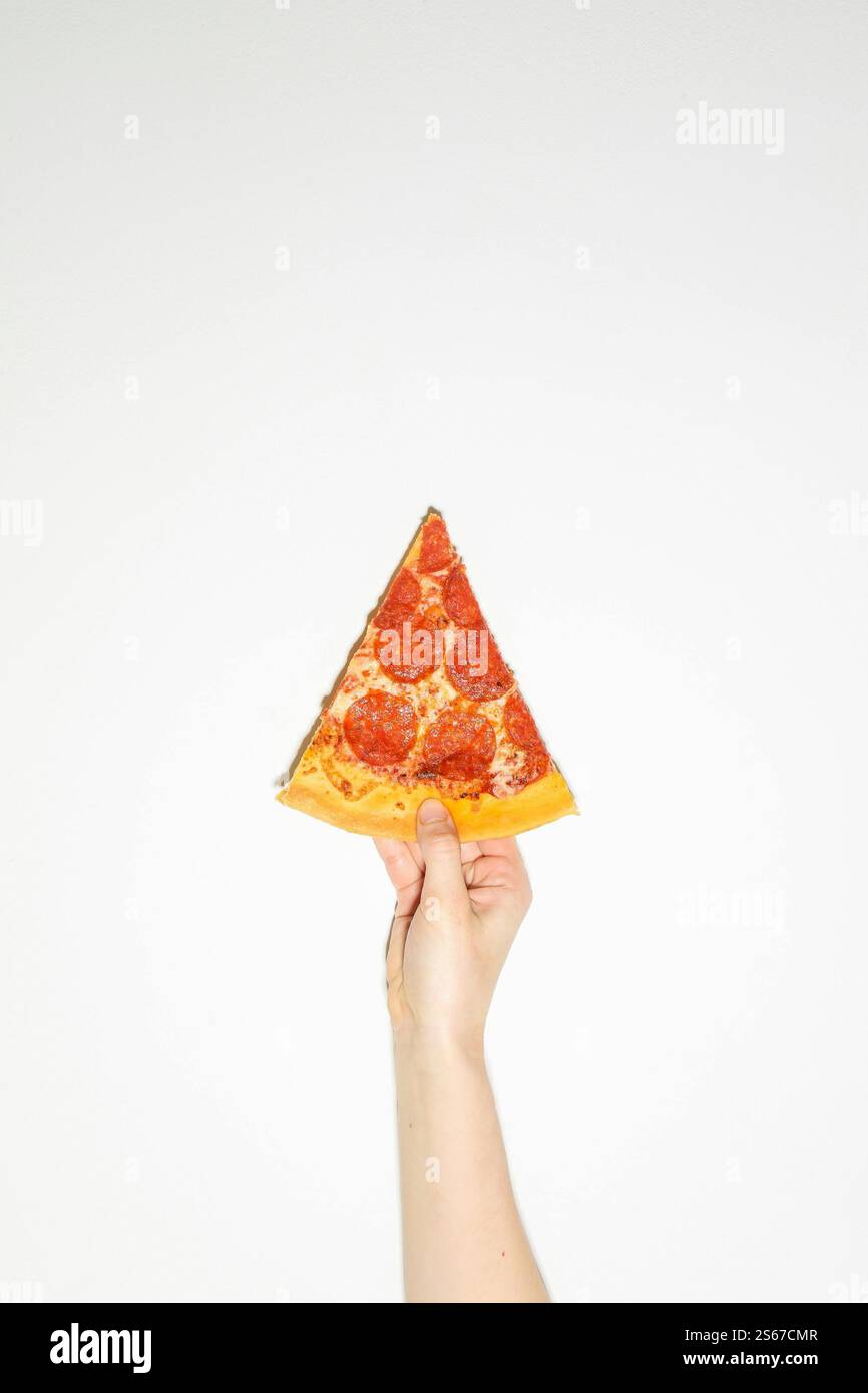 Pizza Slice in Hand Stock Photo - Alamy
