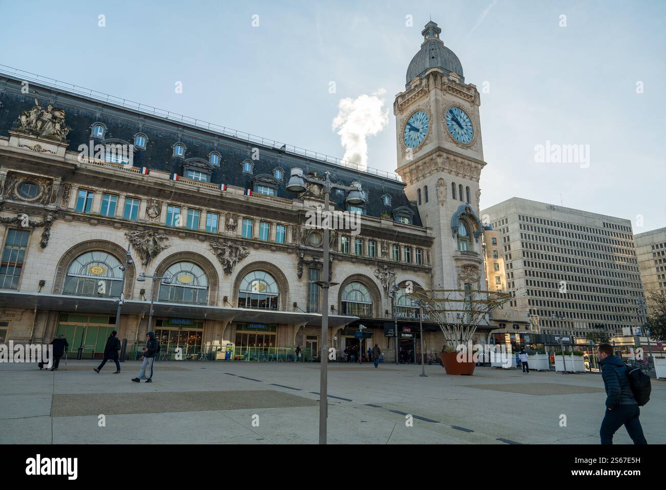 Historic building with clock tower and modern architecture on a clear ...