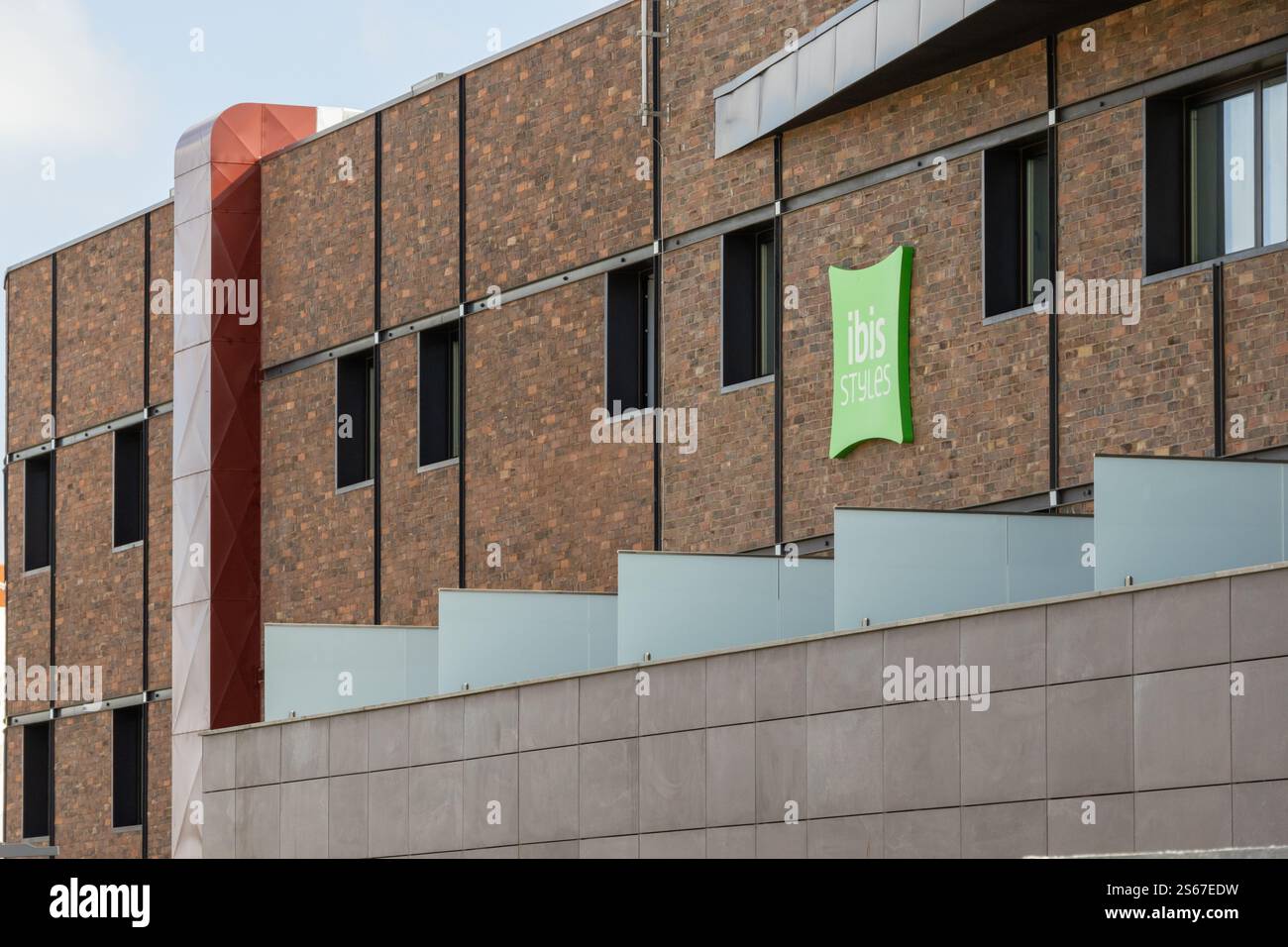 Modern architecture of an ibis styles hotel building with brick facade and green logo Stock ...
