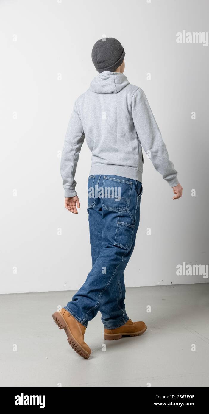 Young boy seen from behind full body walks. White background Stock ...