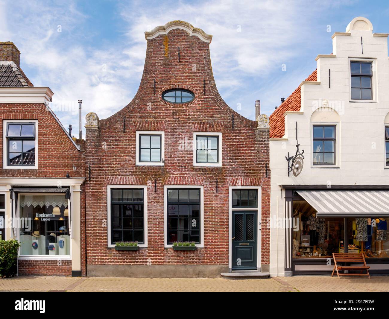 Front view of historic brick townhouse with clock gable in Kerkstraat ...