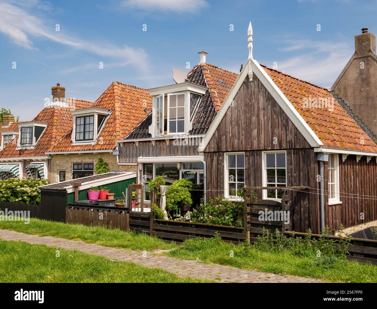 Dike and backyards of historic houses in the old town of Makkum ...