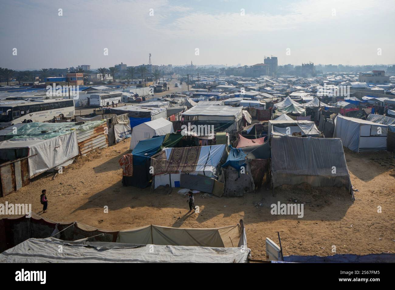Palestinian children play among the tents at a camp for displaced ...