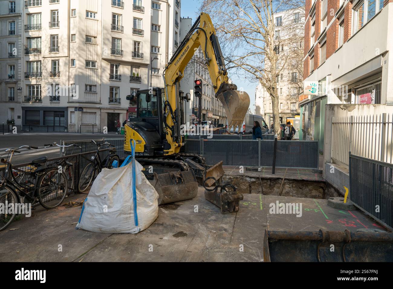 Excavation work taking place on a busy street in an urban area Stock ...