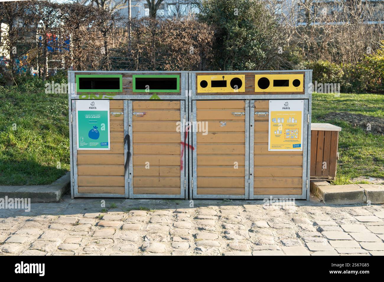 Recycling station with separate bins for plastic, paper, and glass ...