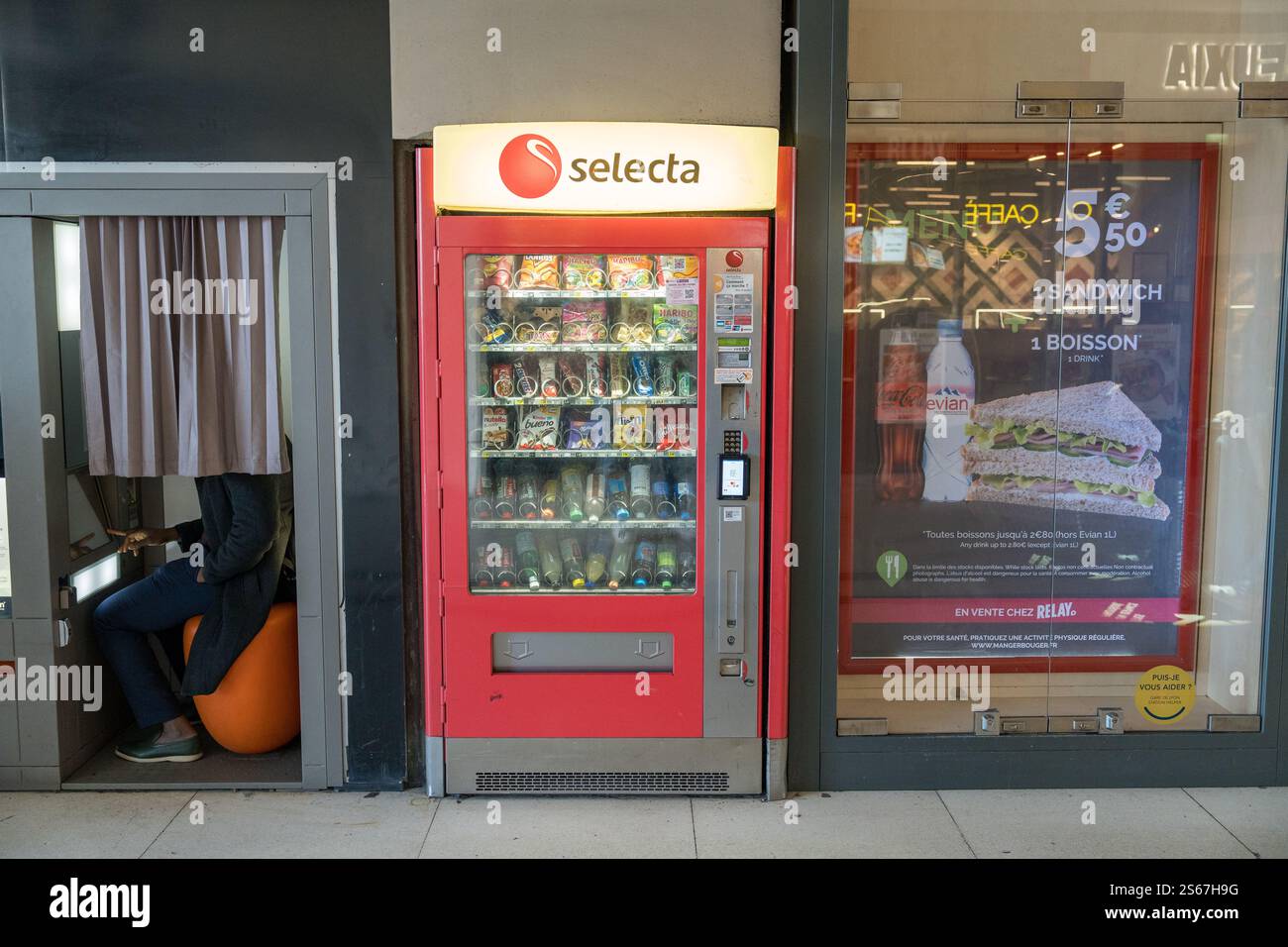 Vending machine with snacks and drinks in urban location near cafe ...